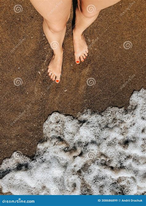 Woman Legs Barefoot At Sea Foam Waves On Sand Beach Summer Day Top