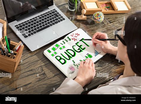 Woman Drawing Budget And Expenses Plan In Notebook Stock Photo Alamy