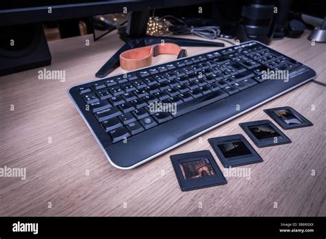 Retro Computer Keyboard And Photo Slides Laying On Wooden Desk With