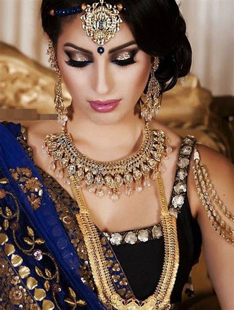 A Shy Bride Decked In Royal Blue Saree And Full Bridal Make Up
