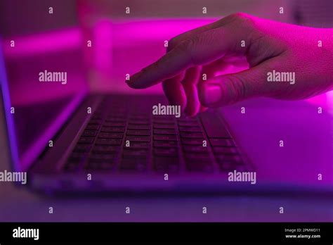 Person Typing At Laptop Computer At Night Female Uses Keyboard Shakes Buttons With Fingers