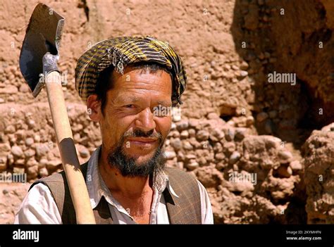 Bamyan Bamiyan Central Afghanistan A Man Carries A Shovel As He Goes To Work In Bamyan