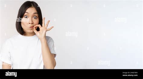 Image Of Young Asian Woman Showing Silence Gesture Zipping Mouth Seal