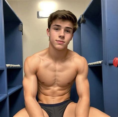 A Shirtless Young Man Sitting On Top Of A Toilet In Front Of Blue Lockers