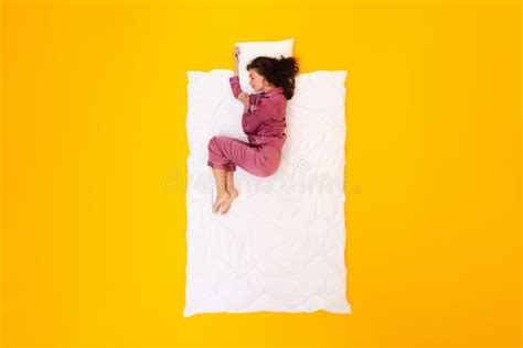 Lady Lying On Blanket Wearing Pajamas Napping Over Yellow Background