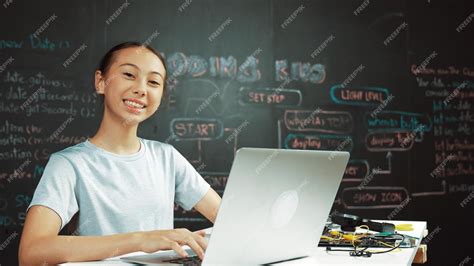 Premium Photo Cute Asian Girl Programing System By Using Laptop At
