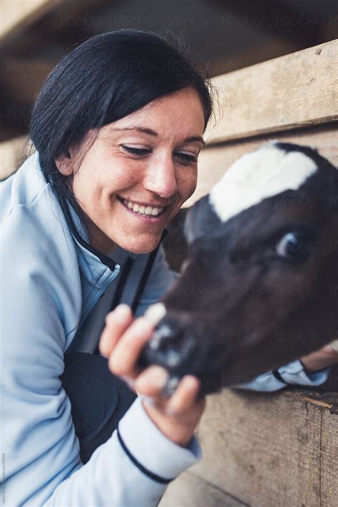 Woman Playing With Calf By Stocksy Contributor Mauro Grigollo Stocksy