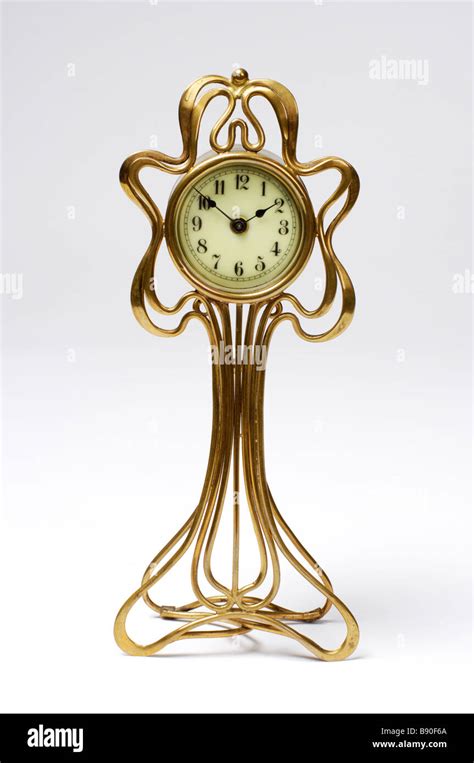 A French Art Nouveau Table Clock With Brass Case And Enamelled Dial
