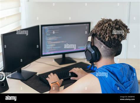 Software Engineer Sitting At Desk And Typing On Computer Keyboard While