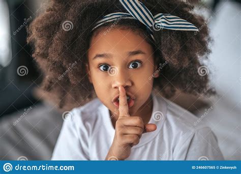 A Sweet Girl Showing Silence Sign And Looking Excited Stock Image