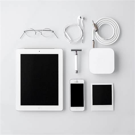 Assortment Of Apple Products And Accessories On White Surface