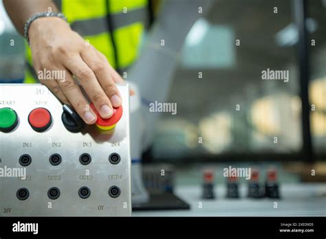 Close Up Of Hand Pressing The Stop Button On The Control Panel Of An