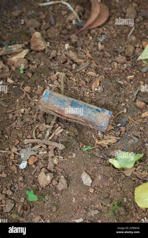 Close Up Of Discarded Old Corroded Battery Thrown Or Lying On Ground