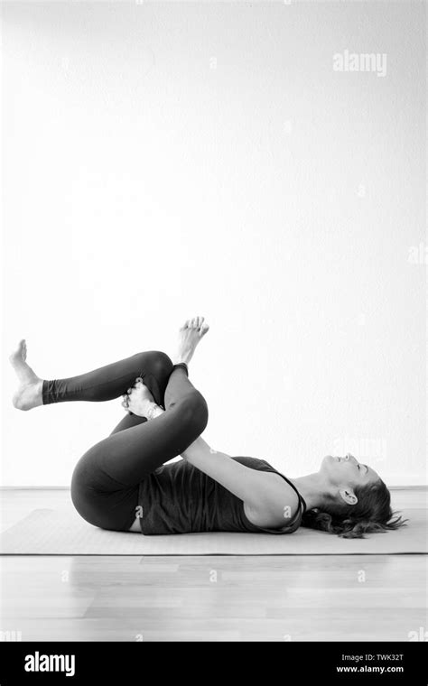 Young European Brunette Woman On Reclining Pigeon Pose Also Called