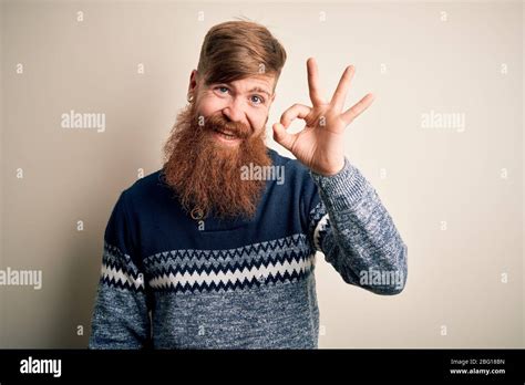 Handsome Irish Redhead Man With Beard Wearing Winter Sweater Over