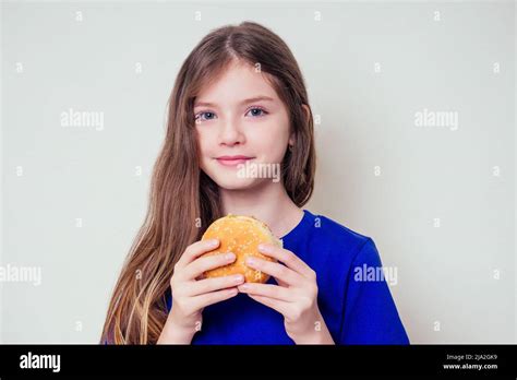 Beautiful Teenager Girl Is Eating Baked Vegetarian Burger With