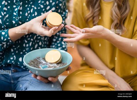 Two Women Sharing Beauty Cosmetics Products Cream In The Metal