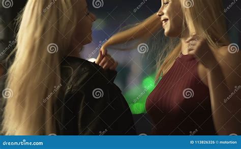 Attracted To Each Other Girls Dancing And Flirting One Touching Hair
