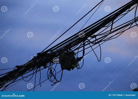 Wire Assemblage A Lot Of Cables And Wires On Pole In The City Against