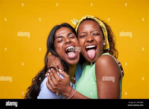 Two Diversity Pretty Positive Girls Stick Out Your Tongue Hugging