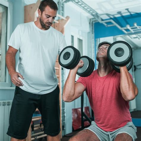 Premium Photo Peronal Trainer With Male Client In The Gym