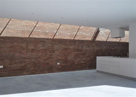 Jack Woolleys Spiral House Hides Itself Behind A Brick Wall