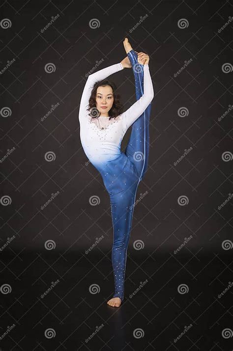 Girl Acrobat Gymnastics A Young Athlete In A Blue And White Suit