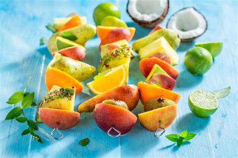 Premium Photo Tasty And Sweet Skewers With Many Exotic Fruits For