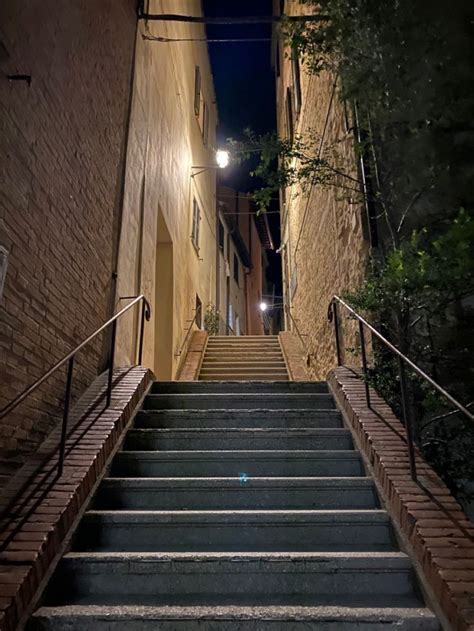 The Stairs Lead Up To An Alleyway At Night