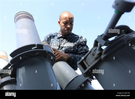 Cryptologic Technician Collection 3rd Class Jamal Brown Loads A Round Into A Chaff Launcher