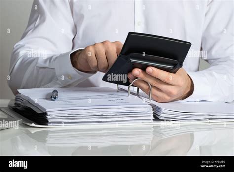 Businessman Calculating Invoice At Desk Stock Photo Alamy