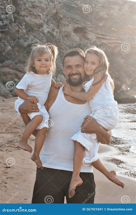 Amor Y Cuidado De Los Padres El Padre Tiene Dos Hijas En Sus Brazos