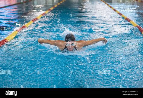 Front View Of A Female Swimmer Swimming Butterfly Style A Stroke