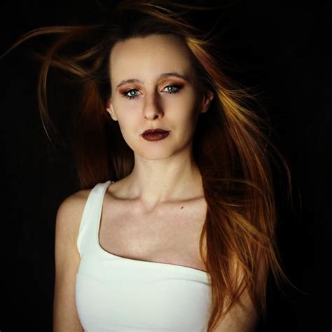 Premium Photo Portrait Of Beautiful Woman Against Black Background