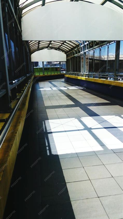 Premium Photo Sunlight Falling On Walkway Through Glass Ceiling