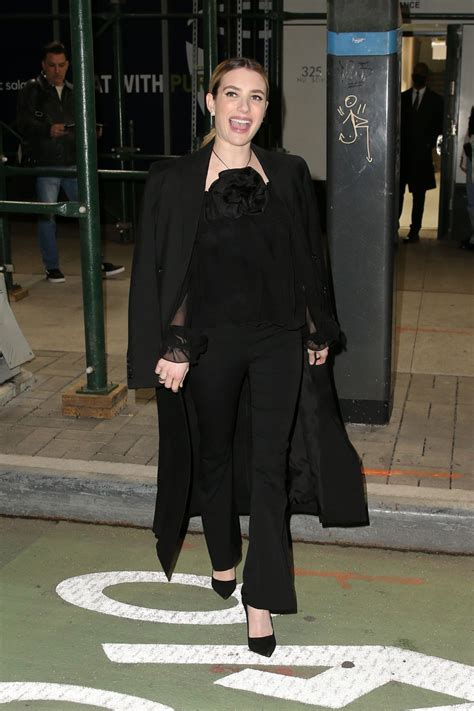Emma Roberts Wearing A Black Top Featuring A Giant Black Rose And Black