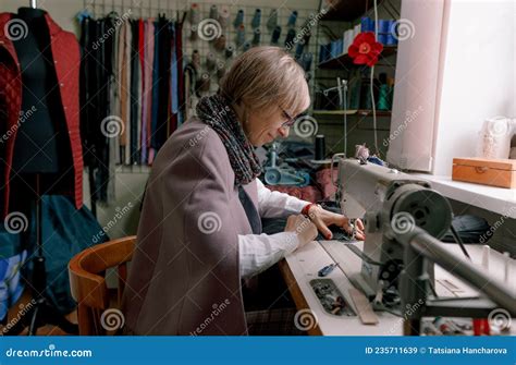 A Female Dressmaker Uses A Sewing Machine To Create Custom Made Clothes