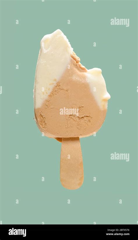 Cheese And Lemon Flavor Popsicle With Couple Of Bites On Green