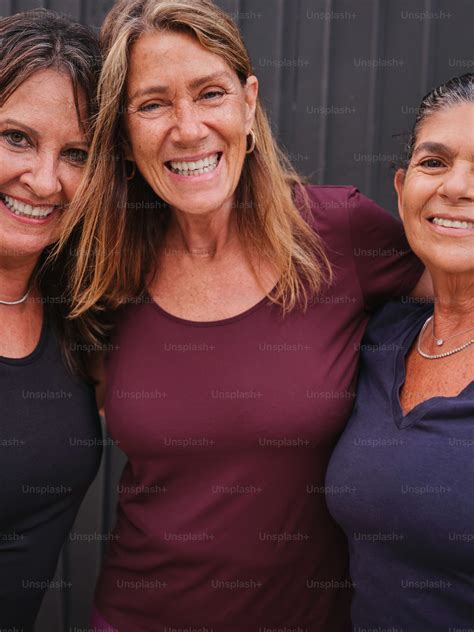 A Group Of Three Women Standing Next To Each Other Photo Portrait