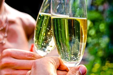Premium Photo Cropped Hands Of Friends Toasting Champagne Flutes In Yard