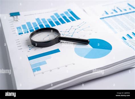 Magnifying Glass On Charts Graphs Paper Financial Development Banking