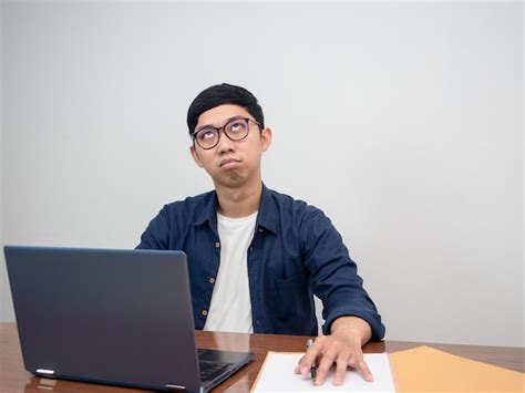 Premium Photo Asian Man Wear Glasses Sitting At Working Table Feels