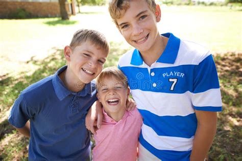 Brotherly Love. Three Brothers Embracing and Smiling at the Camera ...