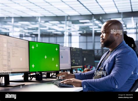 Engineer In Server Hub Using Green Screen Computer To Find Firewall