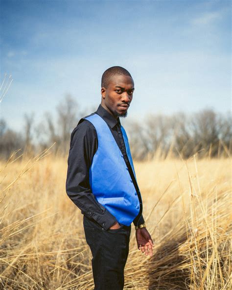 Man In Black Vest And Blue Dress Shirt Standing On Brown Grass Field