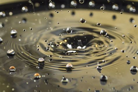 Ferrofluid Separating Into Tiny Droplets Around A Magnetic Array Stock