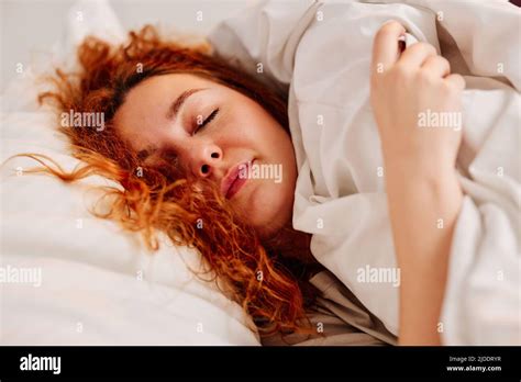 Close Up Of A Redhead Girl Lying In The Bed And Sleeping A Girl Lying