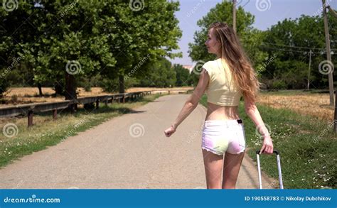 Une Jeune Fille Sexy Fait Du Stop Sur La Route Une Femme Qui Voyage Faisant Du Stop Clips