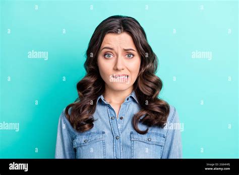 Photo Of Doubtful Sweet Young Lady Dressed Denim Shirt Biting Lip