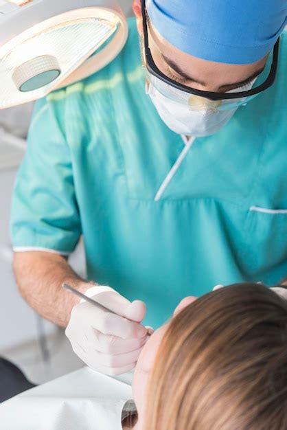 Premium Photo Dentist Performs A Regular Examination Of The Patient